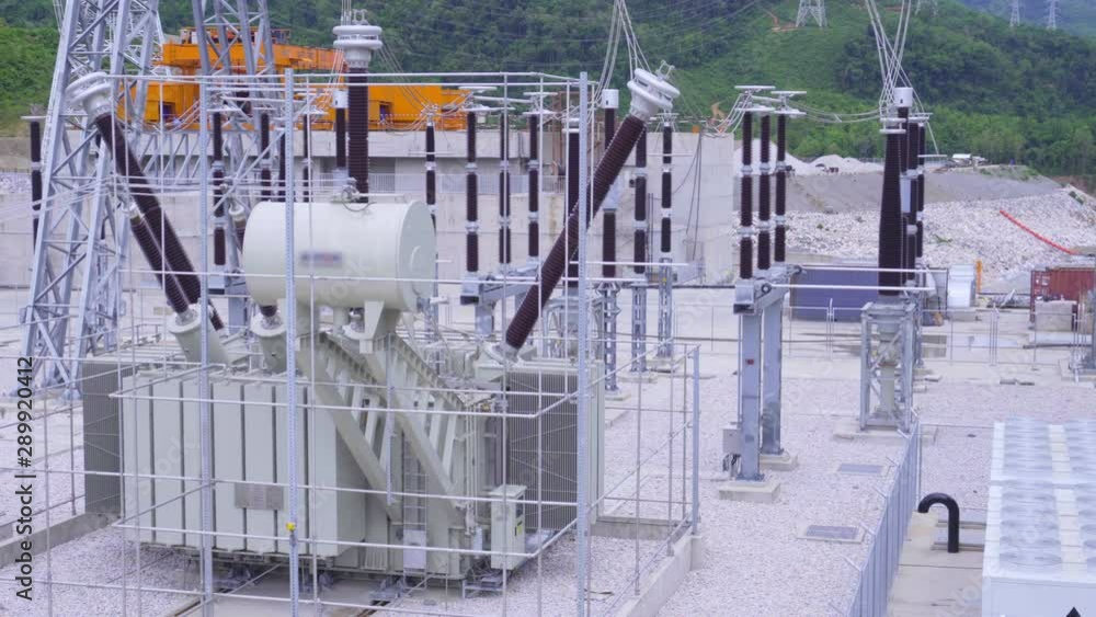 High voltage power plant with electric pole at the hydroelectric dam ...