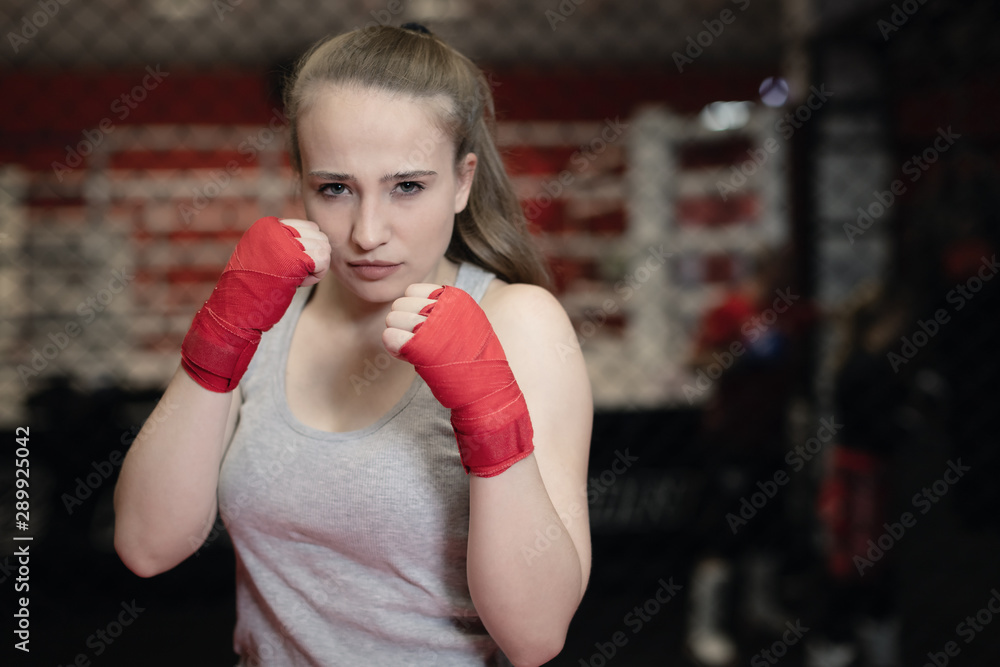 angry young fighter woman with his hands wrapped in Boxing bandages ...