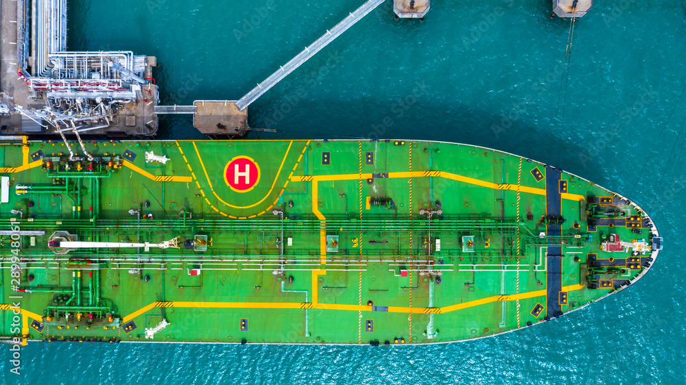 Aerial top view of fuel tanker ship at the port, Oil terminal is ...