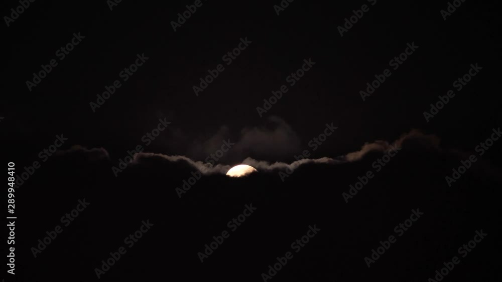 Full Moon Moves in the Night Sky through Dark Clouds. Time lapse. The ...