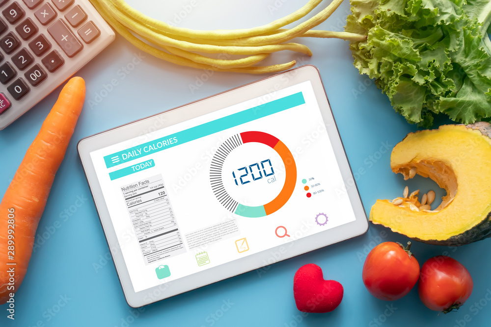 Calories counting , diet , food control and weight loss concept. tablet ...