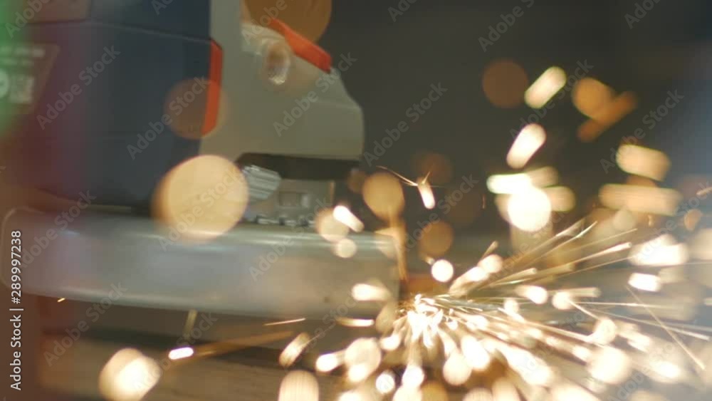 Impressive spark shower of angular grinder. A metal worker is cleaning ...