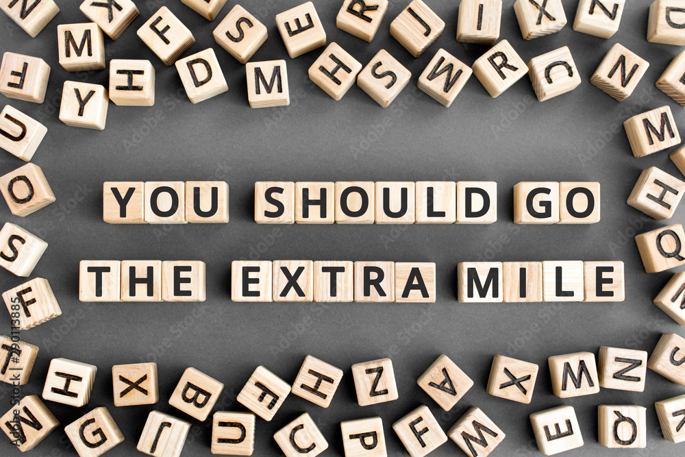 You should go the extra mile - phrase from wooden blocks with letters ...