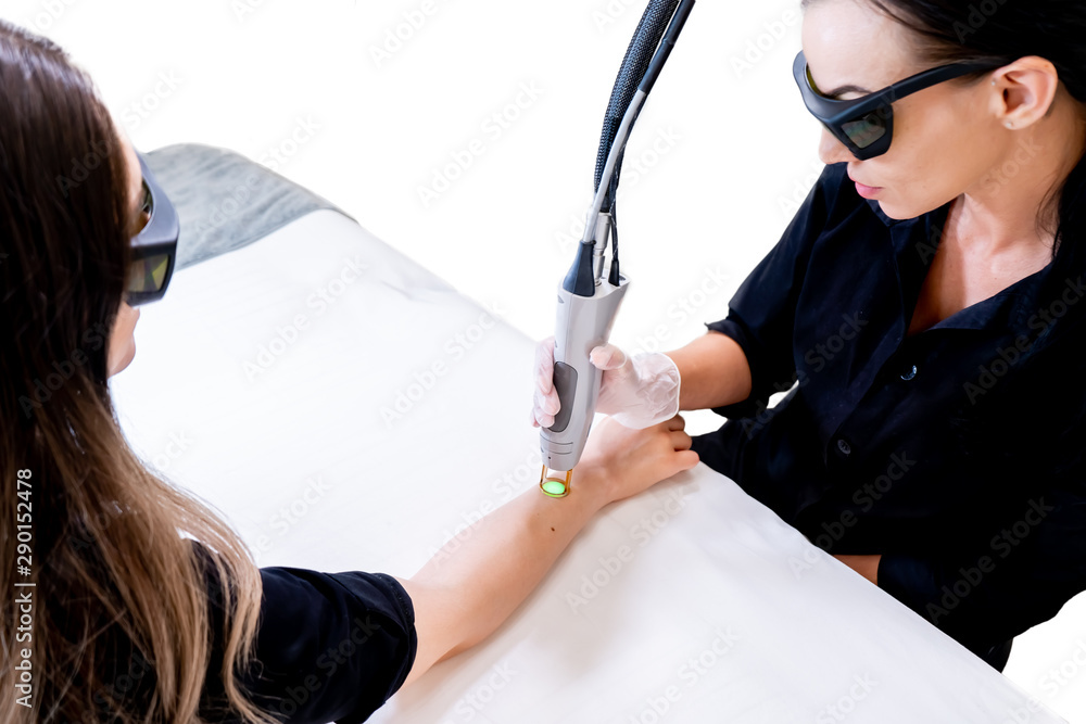 Laser hair removal session with beauty technician and female patient ...