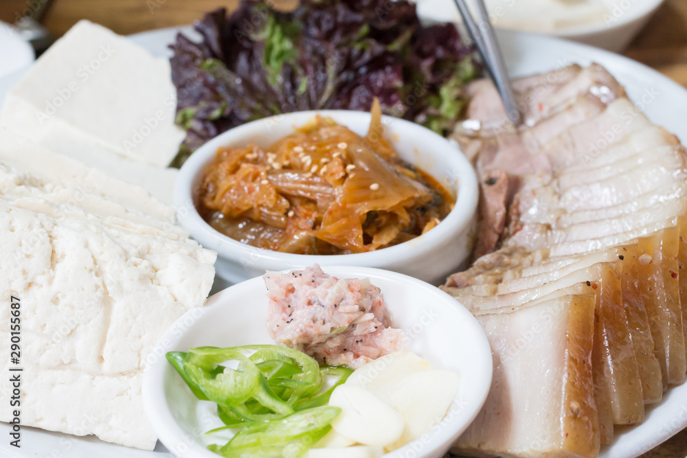 Korean traditional food bossam, boiled pork eaten with bossam kimchi ...