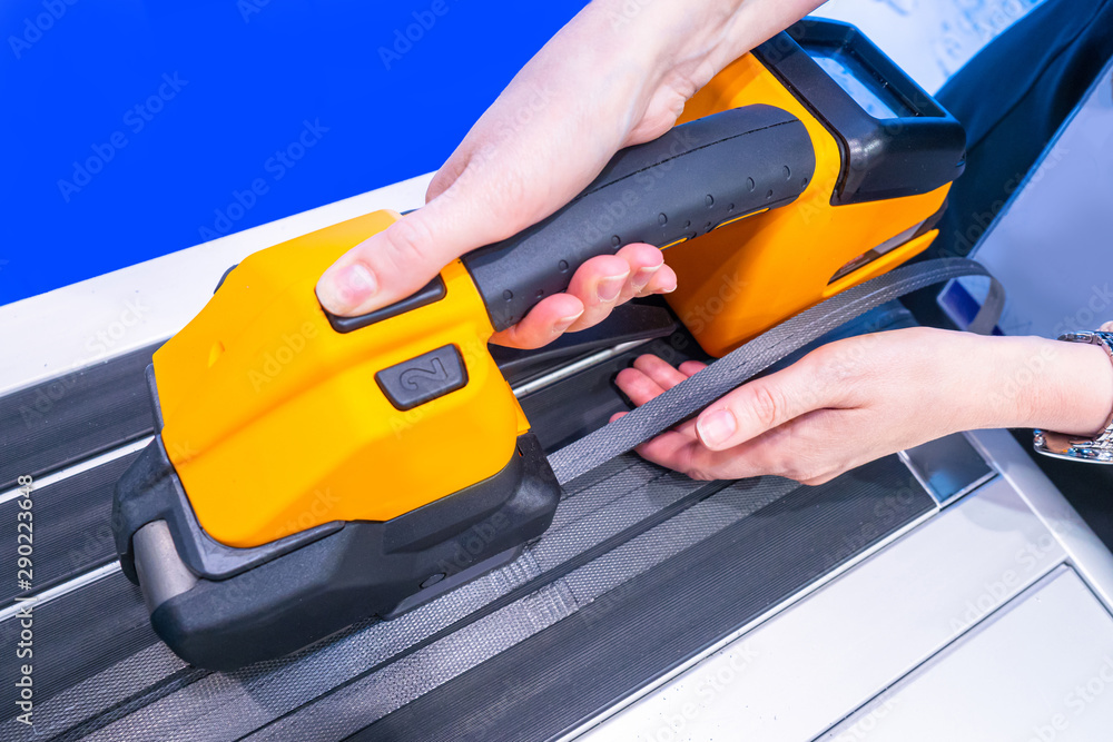 Hand tool for packing boxes with plastic tape. Strapping machine close ...