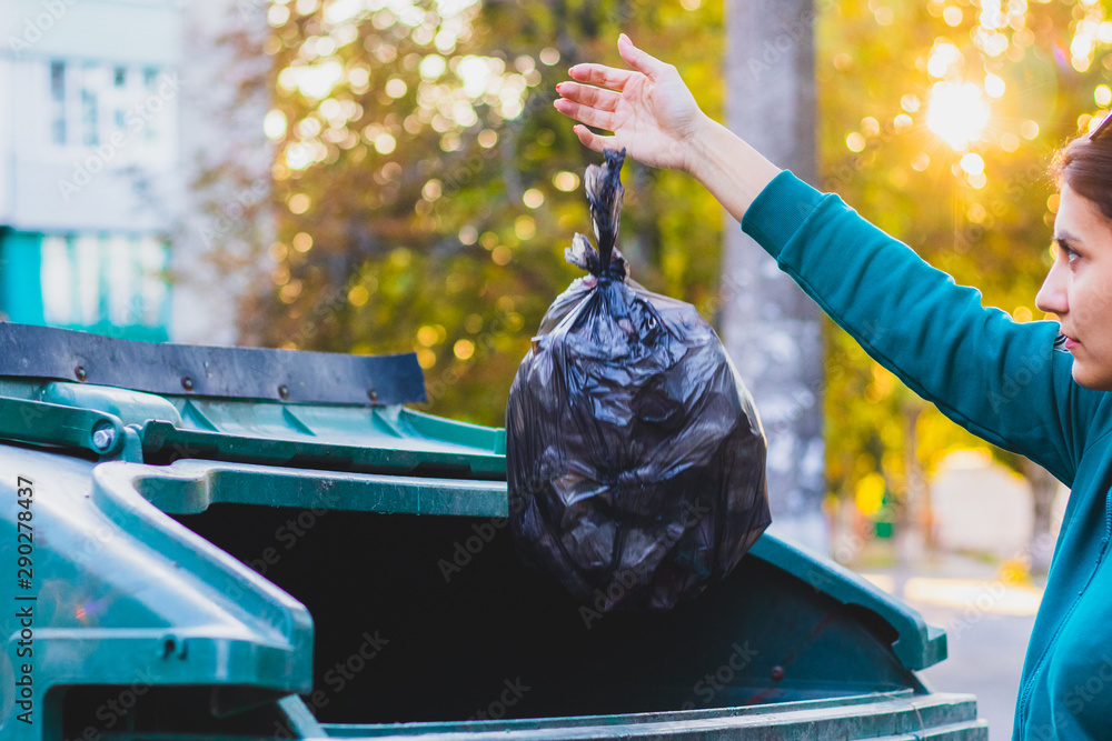 Garbage being thrown into a trash container. Plastic and food waste ...