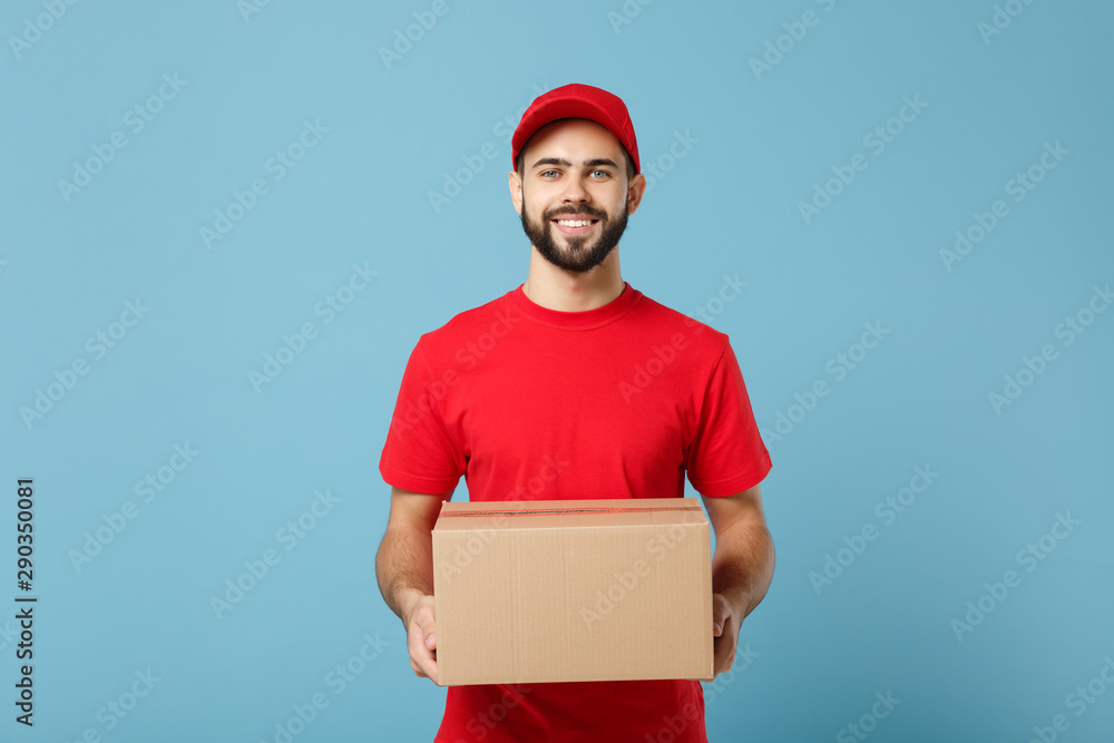 Delivery man in red uniform isolated on blue background, studio ...