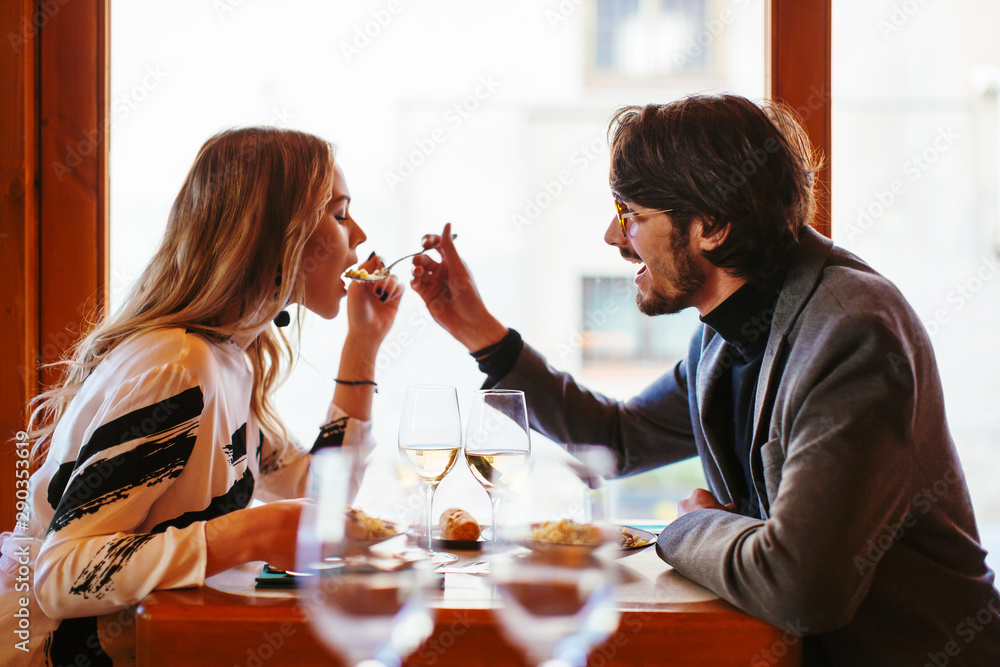 Side view of couple dining in restaurant. Stock Photo | Adobe Stock