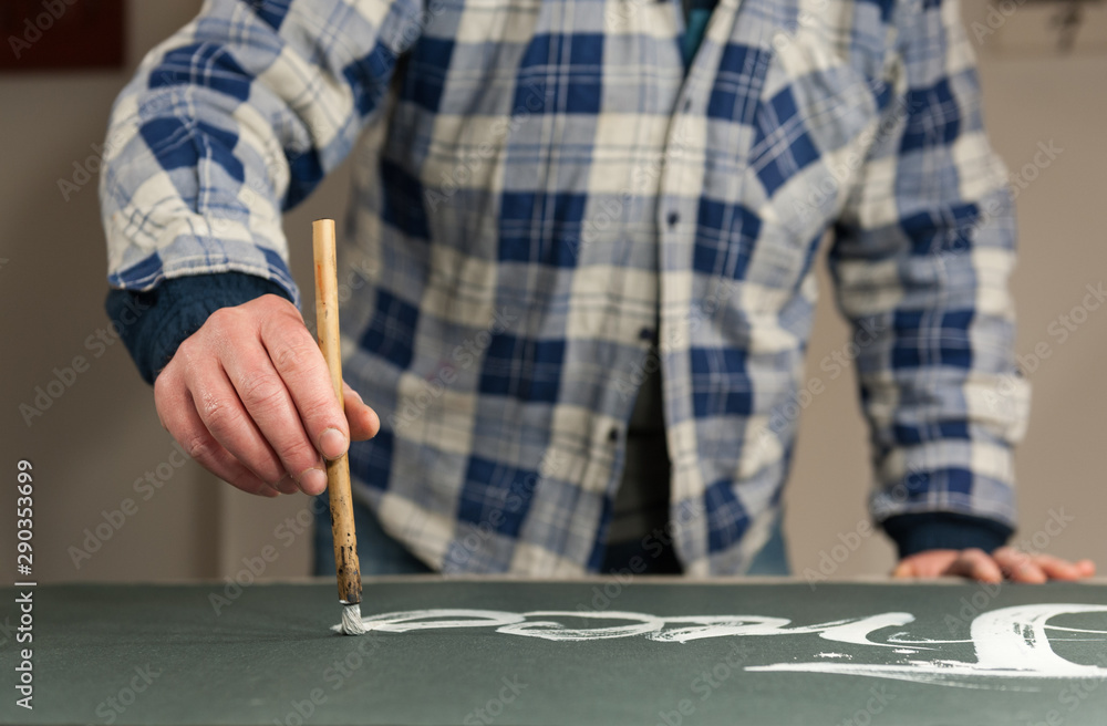 A Master Calligrapher writing using a special paintbrush Stock Photo ...