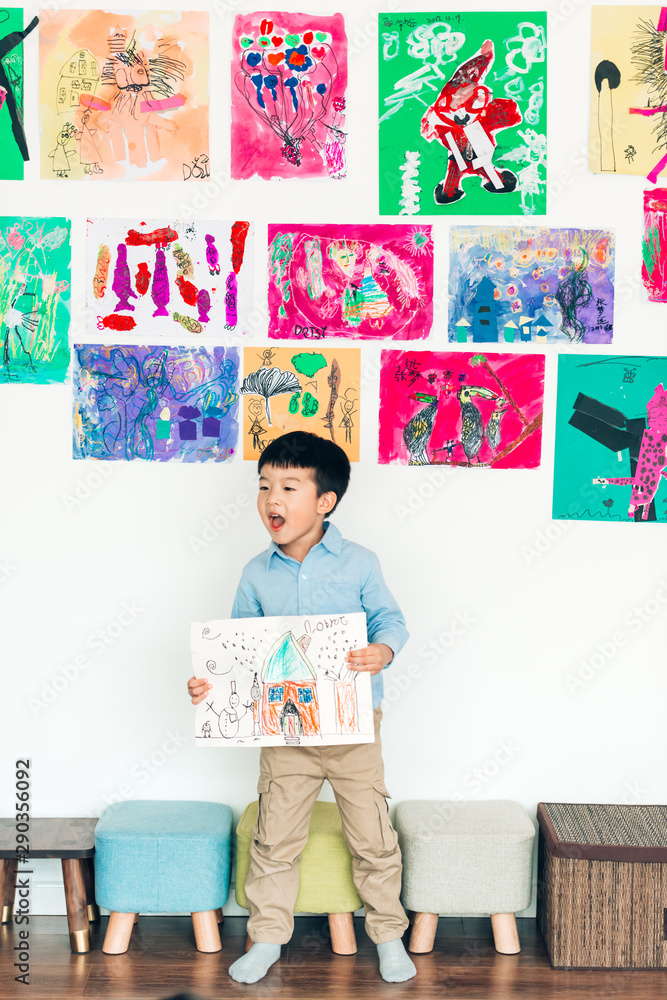 Preschool kids showing drawings in classroom Stock Photo | Adobe Stock
