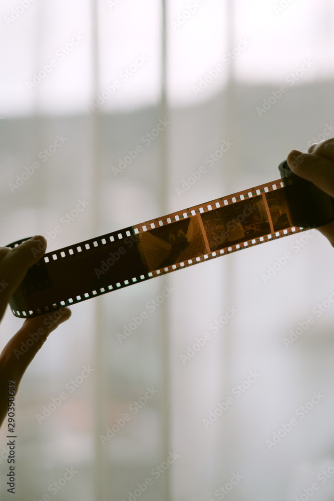 Looking at the developed film roll Stock Photo | Adobe Stock