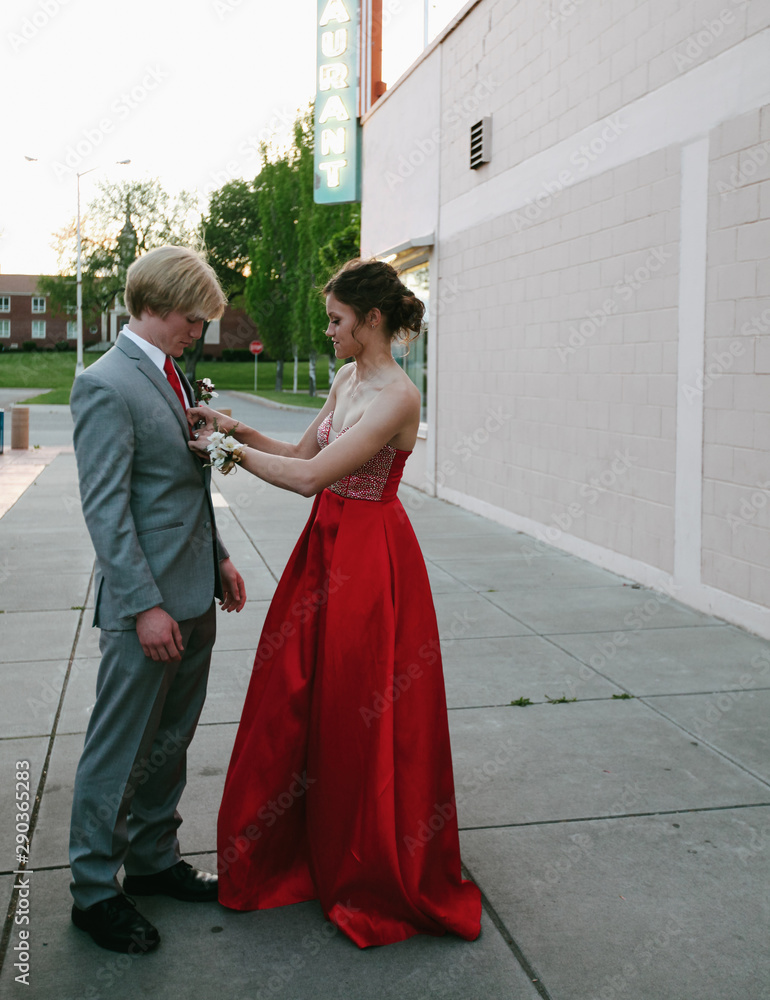 teenage couple dressed up for high school prom having fun before the ...