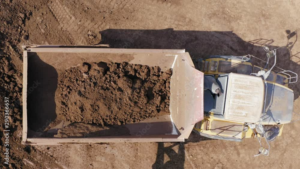 Excavator loading soil onto an Articulated hauler Truck, Top down ...