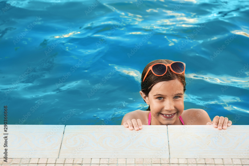 Happy cute girl with sunglasses in swimming pool Stock Photo | Adobe Stock