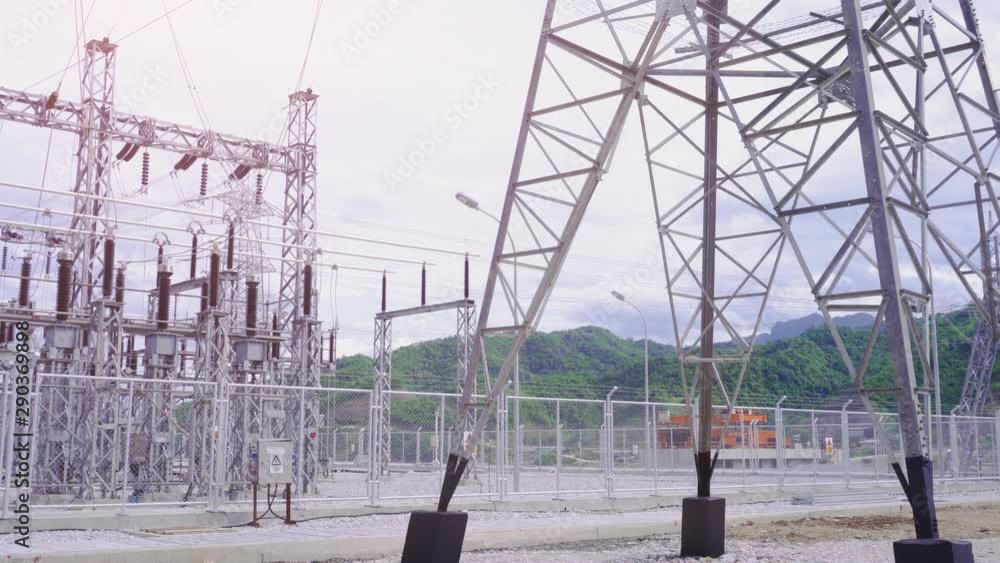 High voltage power plant with electric pole at the hydroelectric dam ...