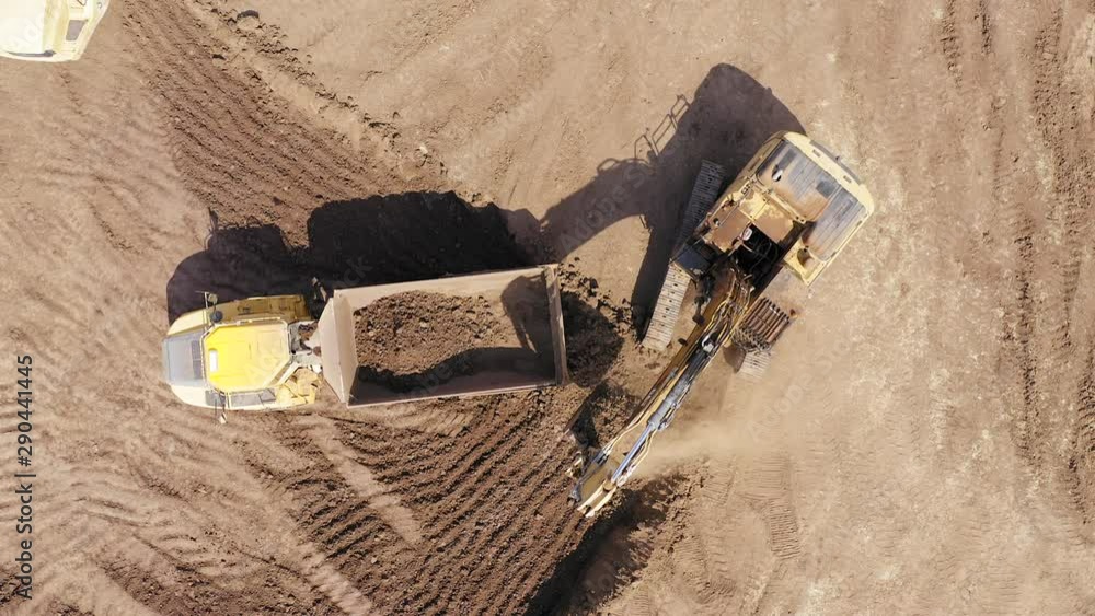 Excavator loading soil onto an Articulated hauler Truck, Top down ...