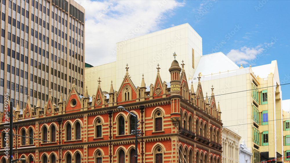 The historic landmark Beehive Corner built in 1895 against modern ...