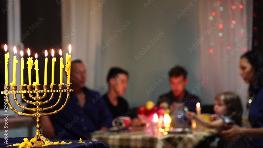 Jewish family Celebrates Hanukkah by lighting menorahs at sunset Stock ...