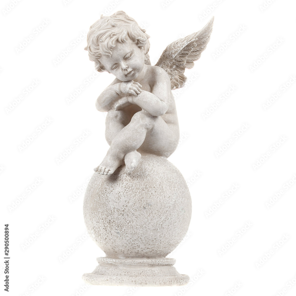 A figurine of a tired little angel from a gypsum resting on a round ...