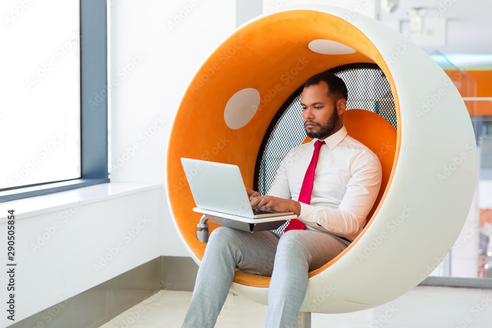 Serious businessman working on computer in office rest room. Business ...