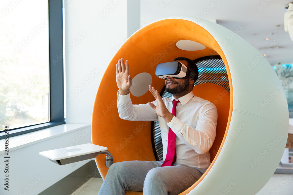 Happy amazed office employee enjoying VR experience. Man wearing VR ...