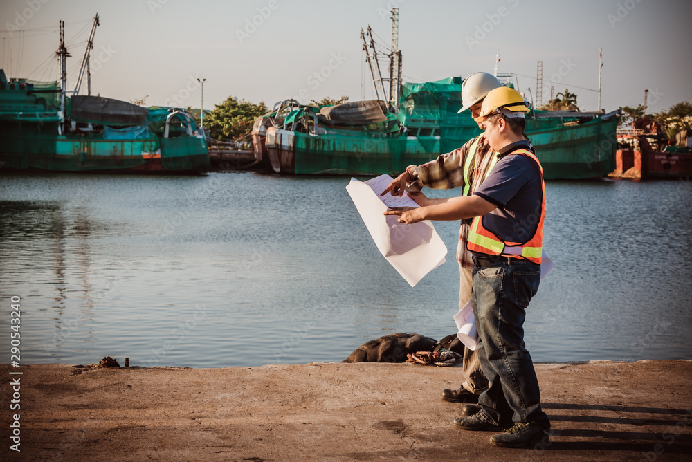 Engineers and technicians Asian man, standing on the dock, helping to ...