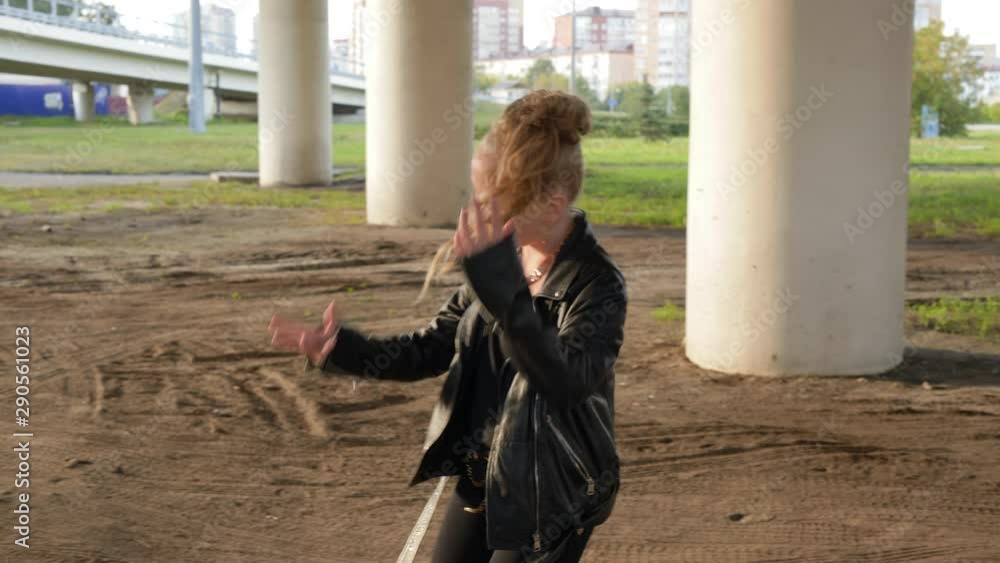 Punk girl dancing on street. Cute smiling teenage girl in leather ...
