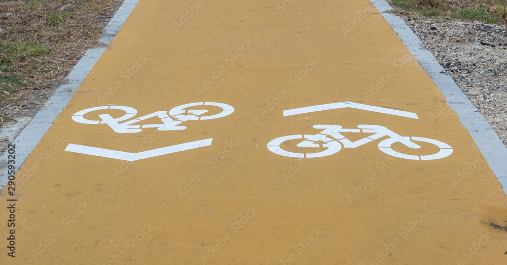 Cycle path with two lanes, and directions marked on the ground. Yellow ...