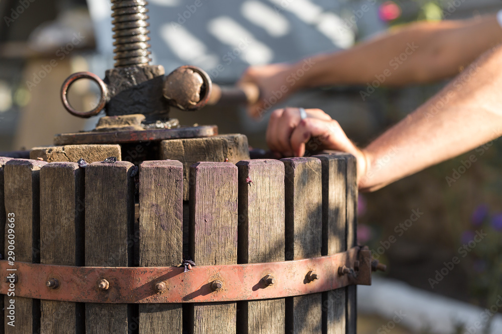 Winepress with red must and helical screw. Traditional old technique of ...