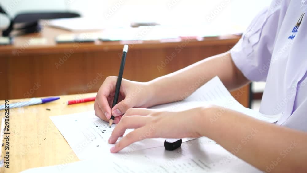Student testing in exam on exercise sheet, taking at school or ...