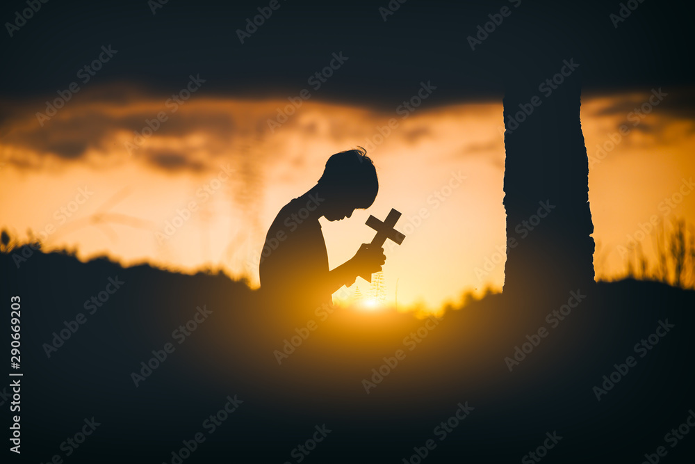 Young man sitting and kneel down for pray and worshipping God with ...
