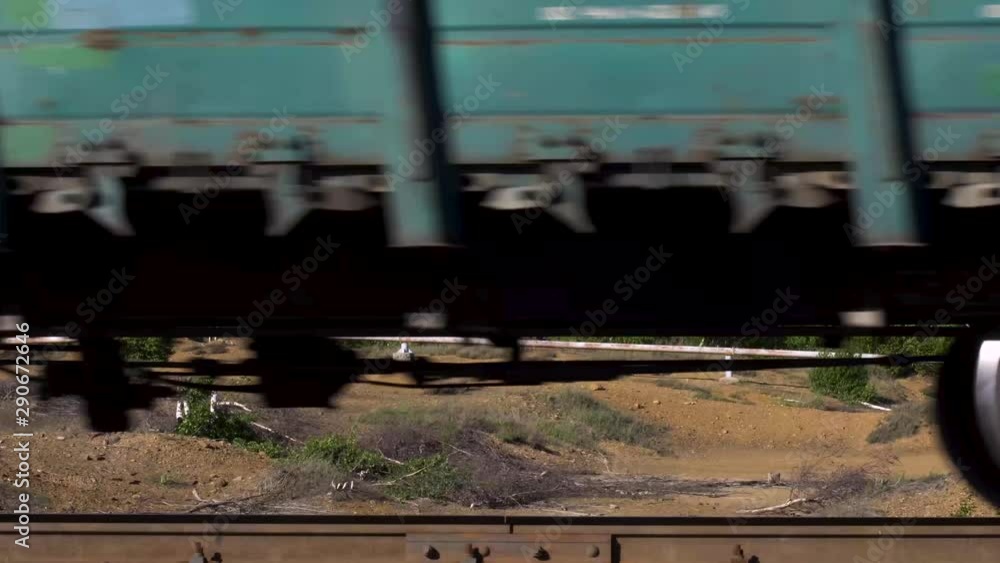 Side view of a freight train moving on rails with beautiful natural ...