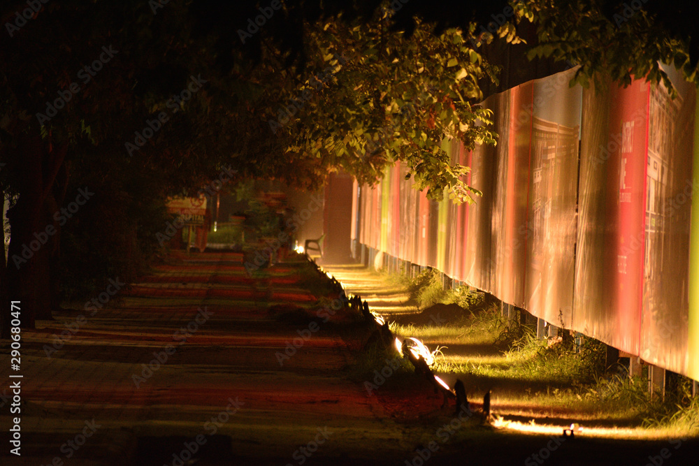 pedestrian foot path lit by flood lights early in the morning Stock ...