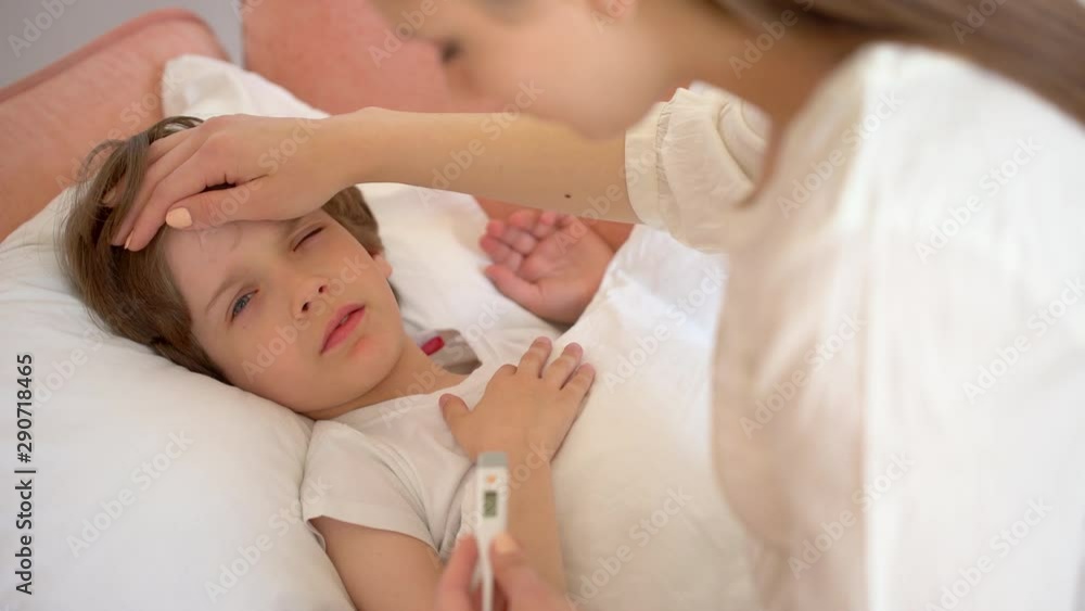 cold flu virus disease, sick kid in bed with thermometer. Sick baby child little boy with high ...