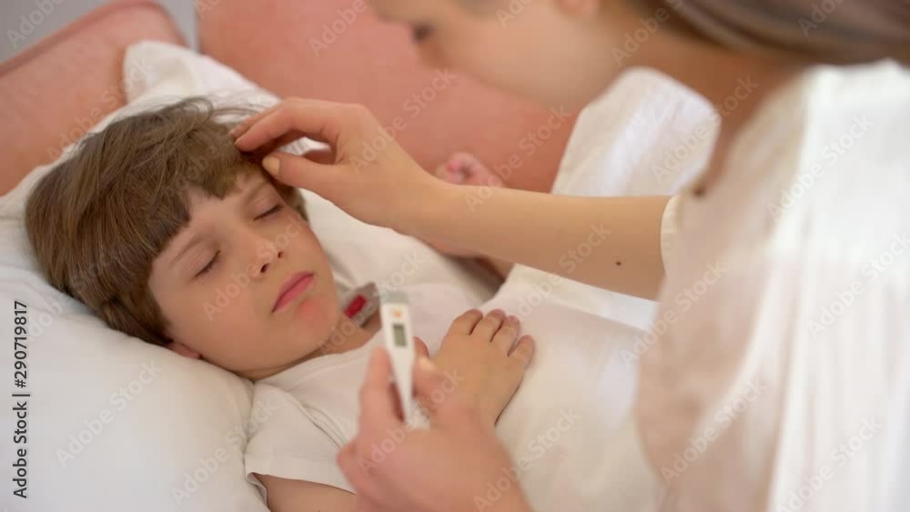 cold flu virus disease, sick kid in bed with thermometer. Sick baby child little boy with high ...