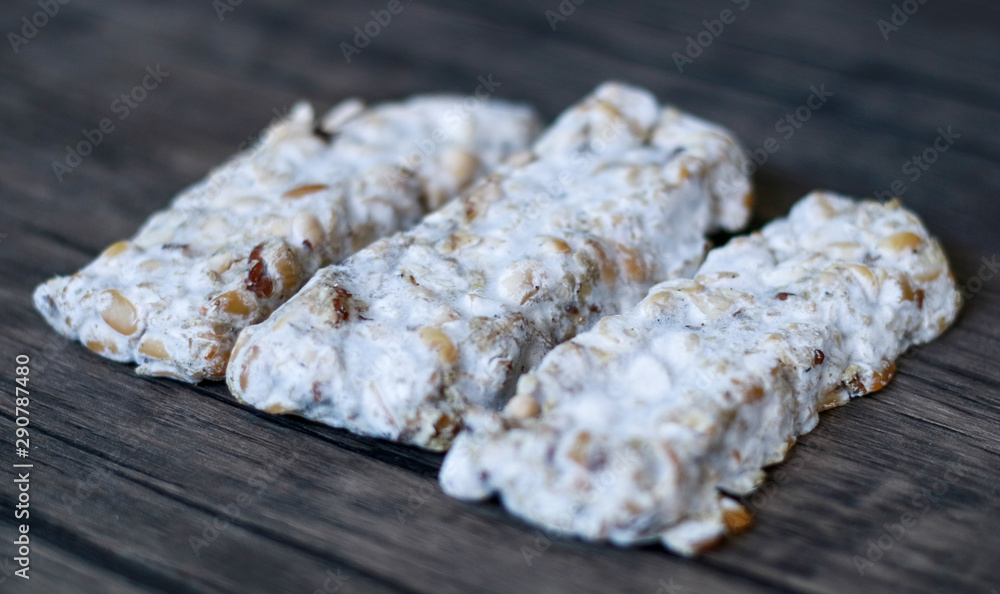 Black oncom on wood background. Oncom is one of the traditional staple ...