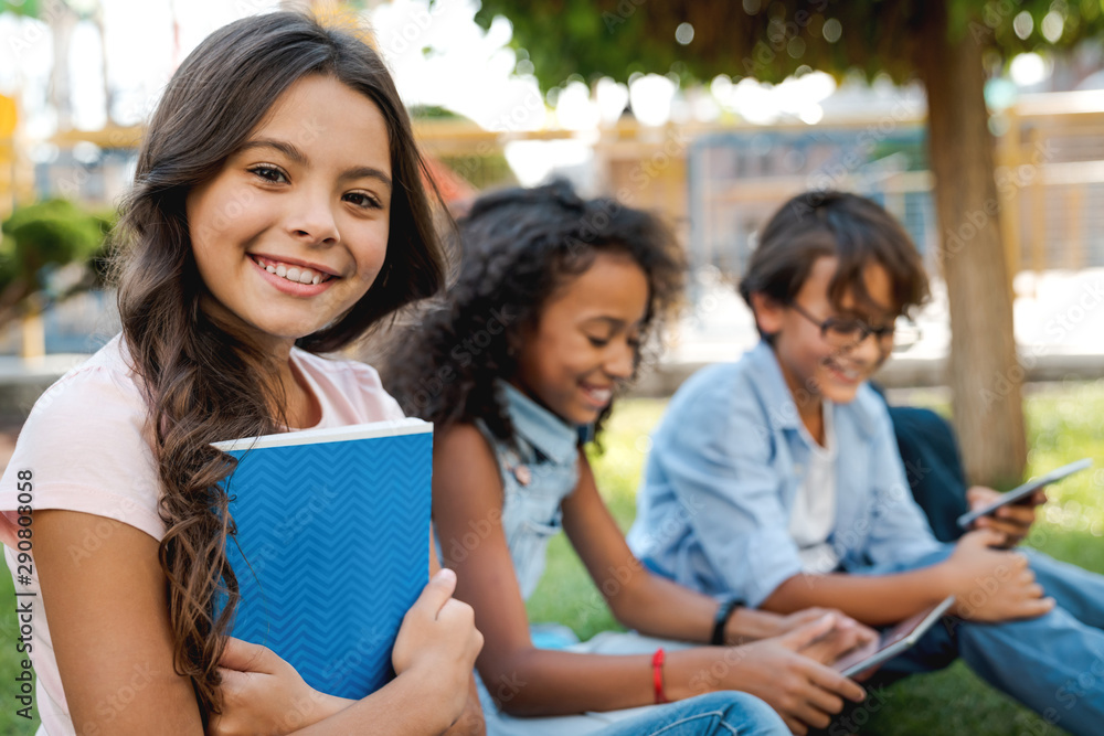 Portrait of cute little school girl and childrens on background with ...