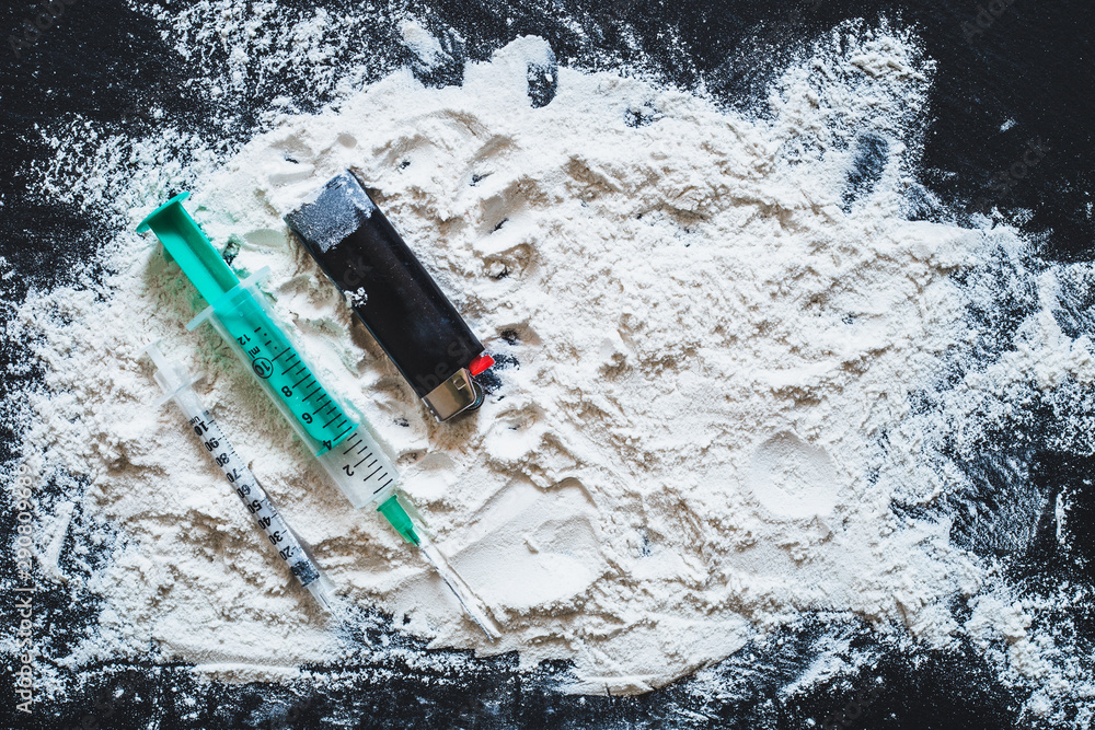 Whote drug powder spread on black background with ,edication, lighter ...