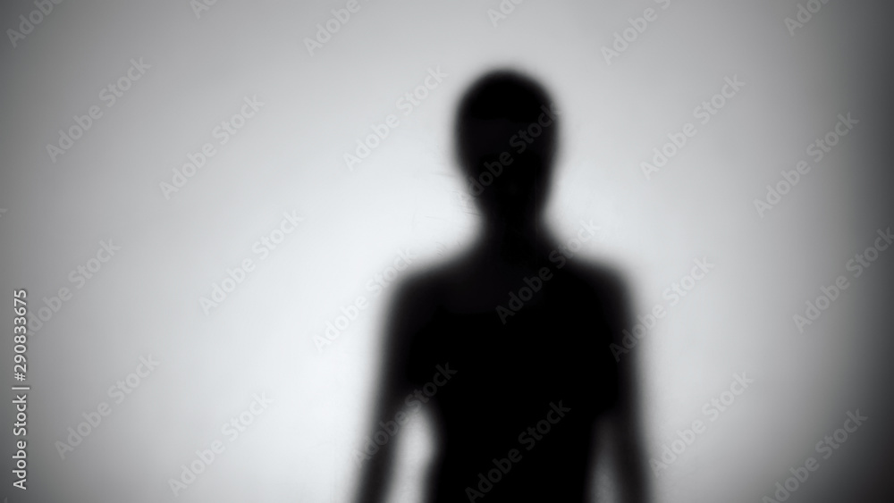 Spooky silhouette of supernatural creature behind glass wall, aliens ...