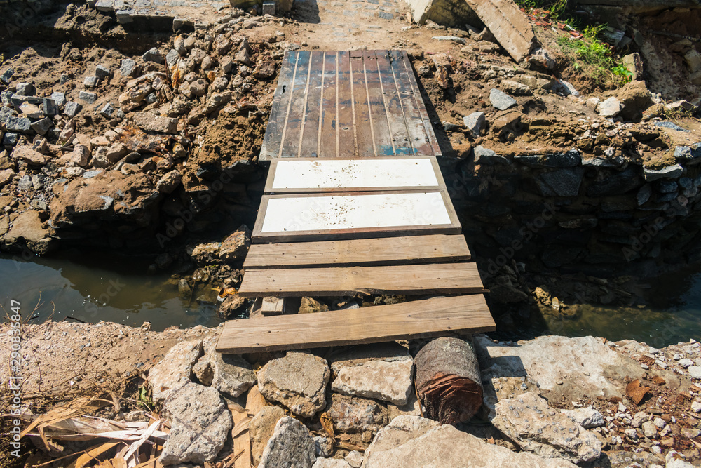 Collapsed bridge after heavy rainfall "fixed" with coconut tree trunks ...