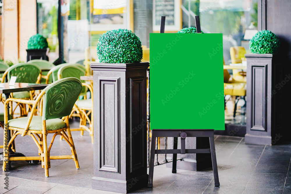 Blank green screen outdoor advertising board with wooden stand on floor ...