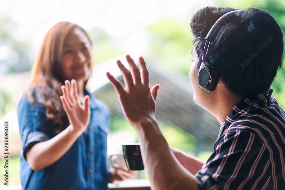 Foto de A man greeting and say hi to his female friend while enjoy ...
