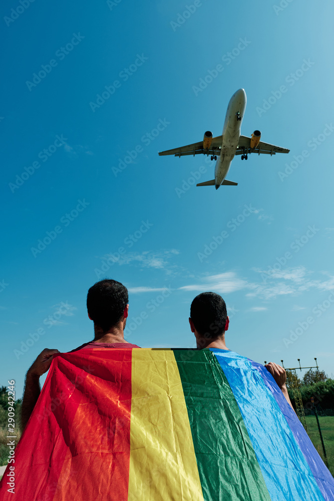 two gay man with the gay pride flag and an airplane Stock Photo | Adobe ...