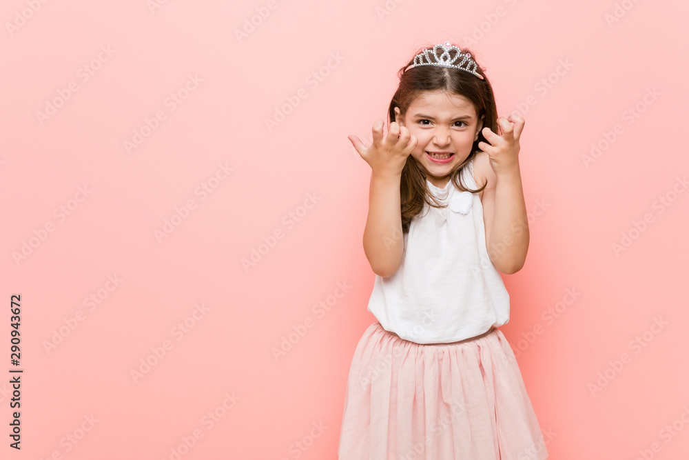 Little girl wearing a princess look upset screaming with tense hands ...