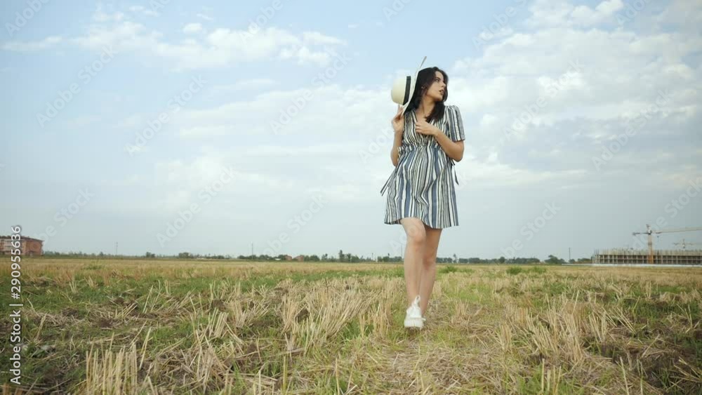 Woman In Hat Walking On Field. Woman In Hat. Romantic Woman Walking On ...