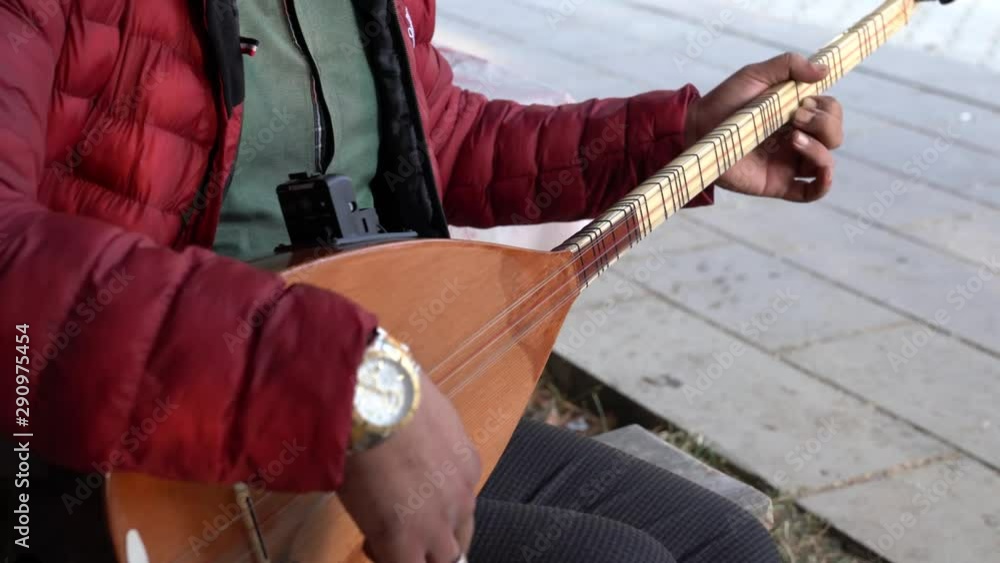 Man playing Turkish musical instrument baglama. Baglama is the most ...
