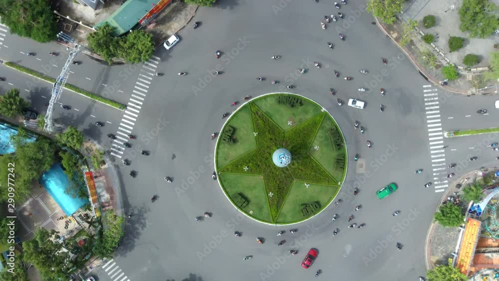 aerial rotating view of a large and grand traffic roundabout which is a ...