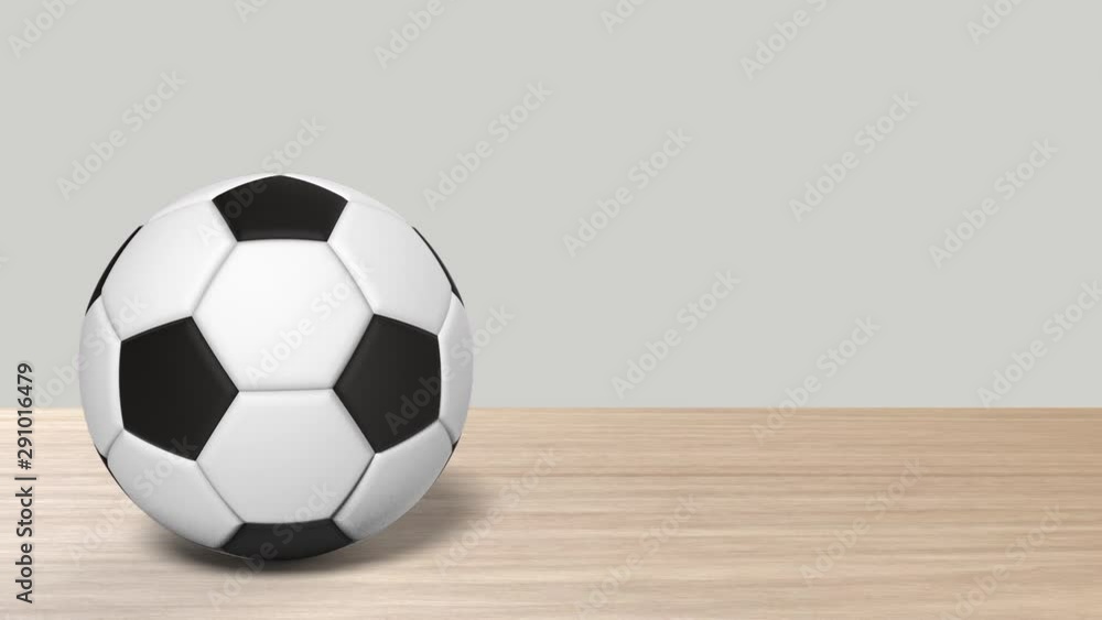 Realistic soccer ball spinning in center on wood table wooden. Footage ...
