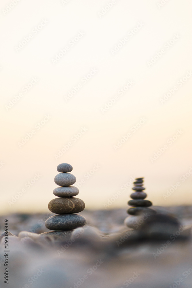 Balanced stone pyramid on pabbles beach with sunset. Zen rock, concept ...